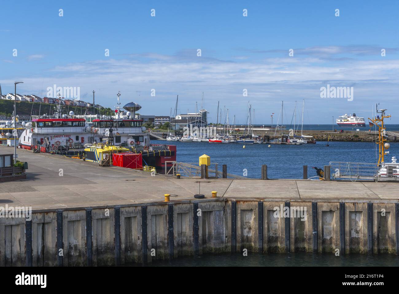 Inland harbour with sailing yachts and offshore supply ships, pier ...