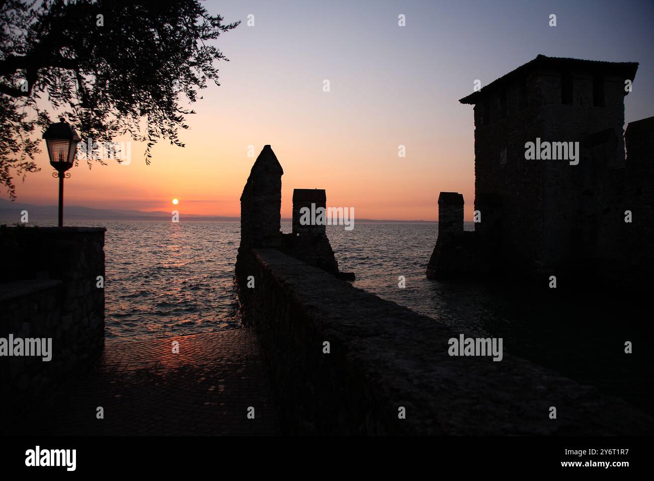 Ancient village of Sirmione built on a peninsula of Lake Garda and ...