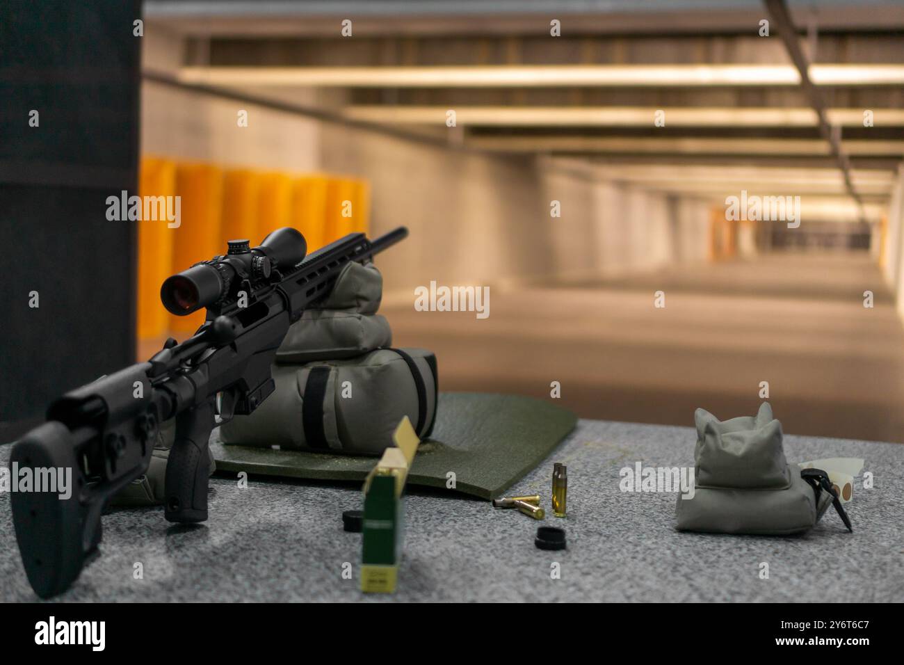 Precision sniper rifle on shooting range mat with ammunition Stock ...