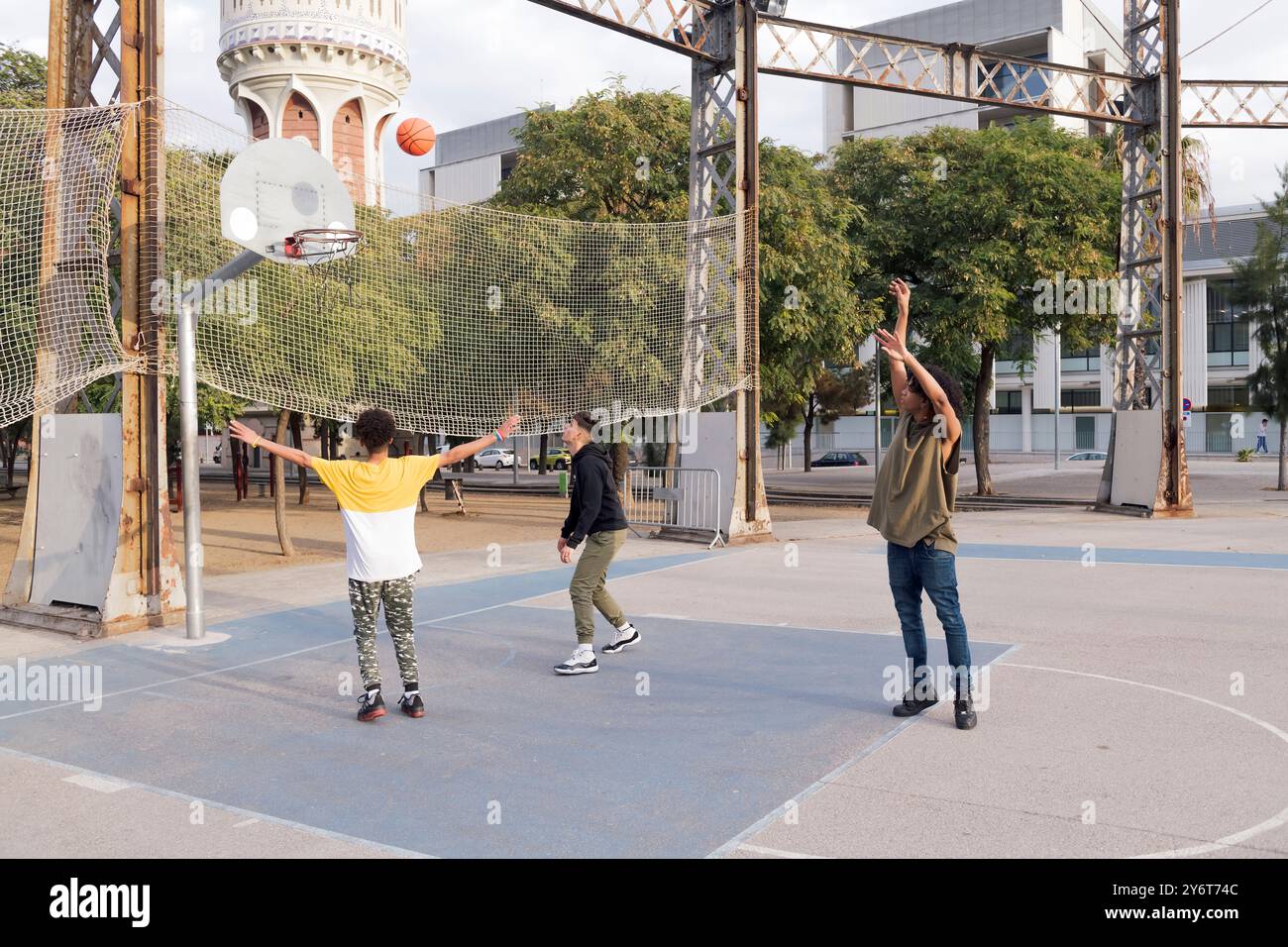multiethnic friends having fun playing basketball Stock Photo - Alamy