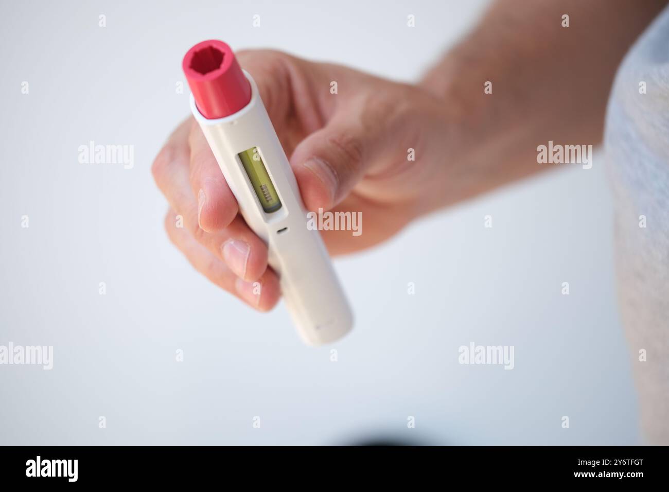 Detail of An anonymous man with pen injector in his hand for a ...