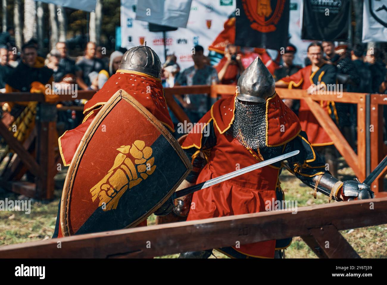 Sword fighting. The knight's shield shows a Golden glove Stock Photo ...