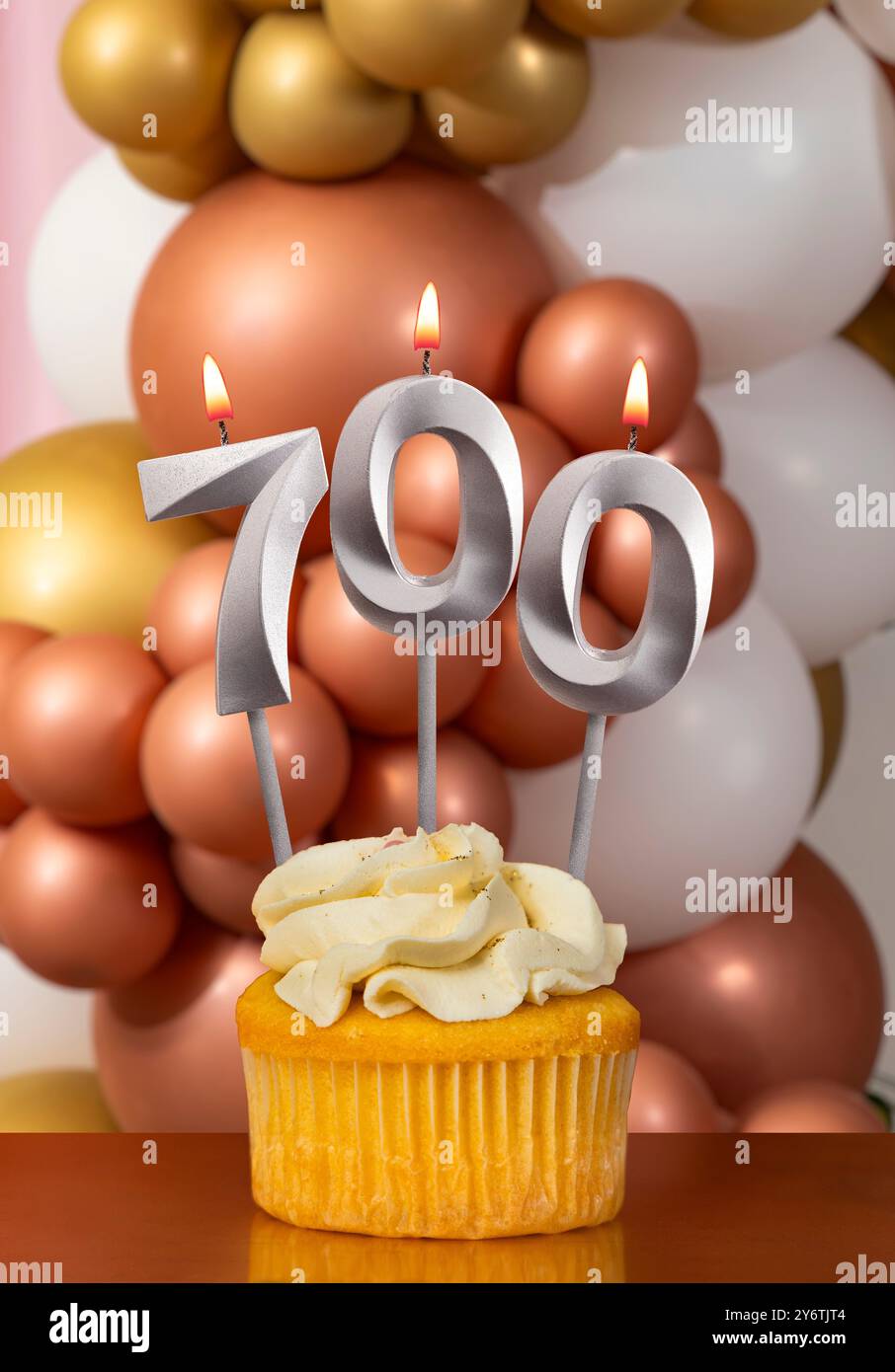 Cupcake with birthday candle on balloons background - Number 700 Stock ...