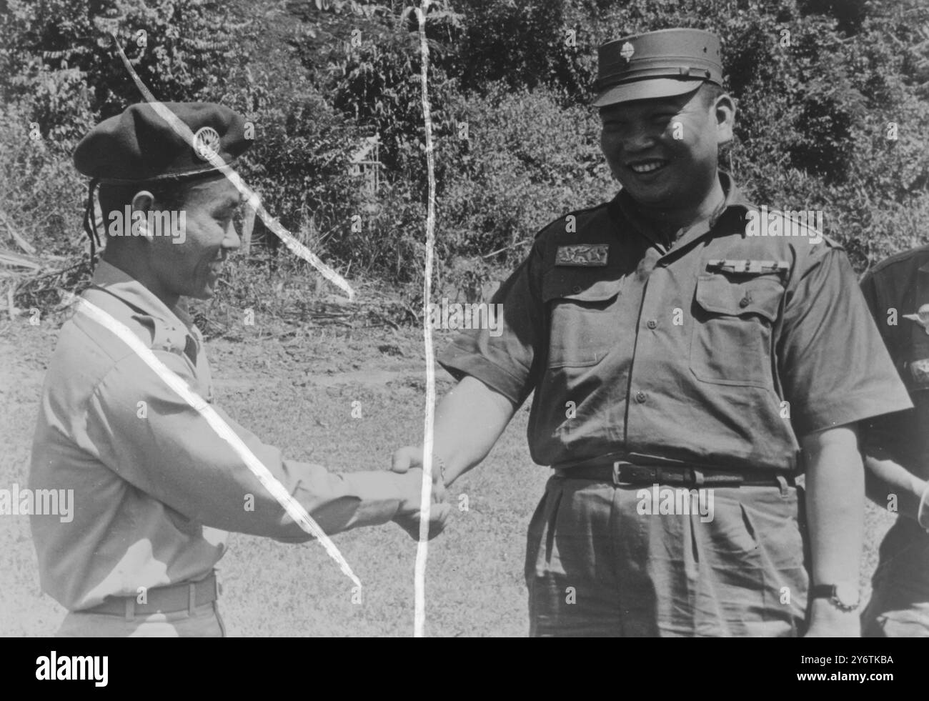 Hin Heup , Laos : Major General Kong Le (left) shakes hands with his ...