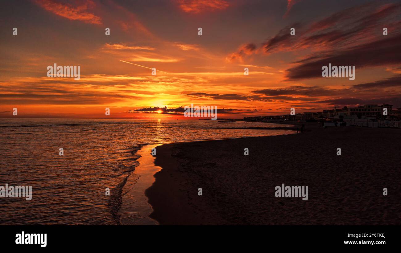 Wonderful golden sunset hour at the beach with skyline of Roman ...