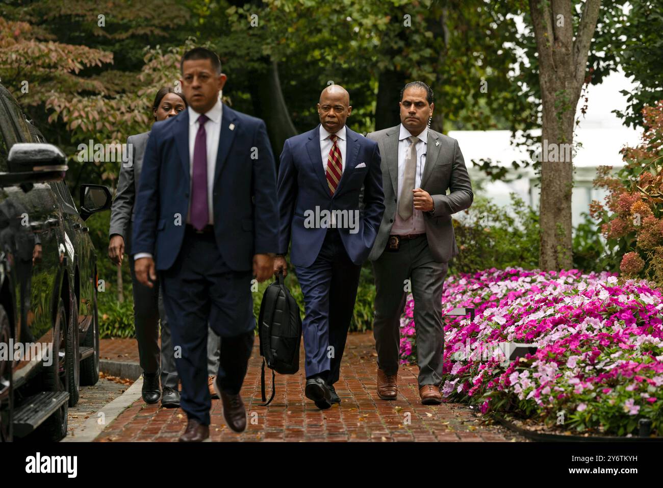 New York City Mayor Eric Adams, second right, exits Gracie Mansion, the ...