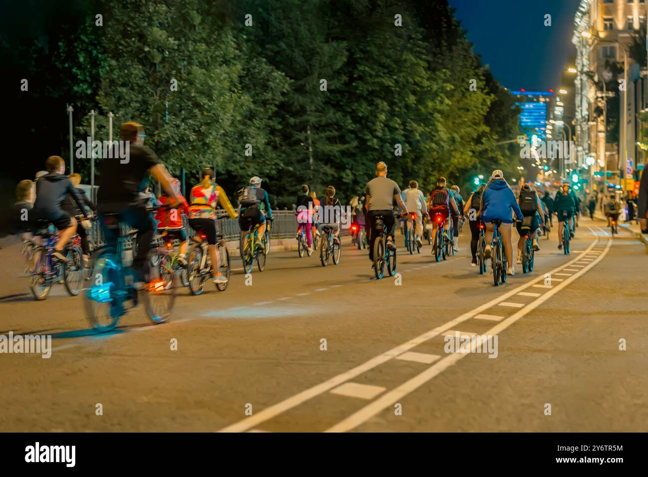 Nighttime bike ride through a city street with cyclists Stock Photo - Alamy