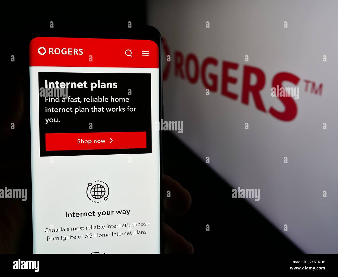 In this photo illustration, a person is holding a mobile phone with the ...