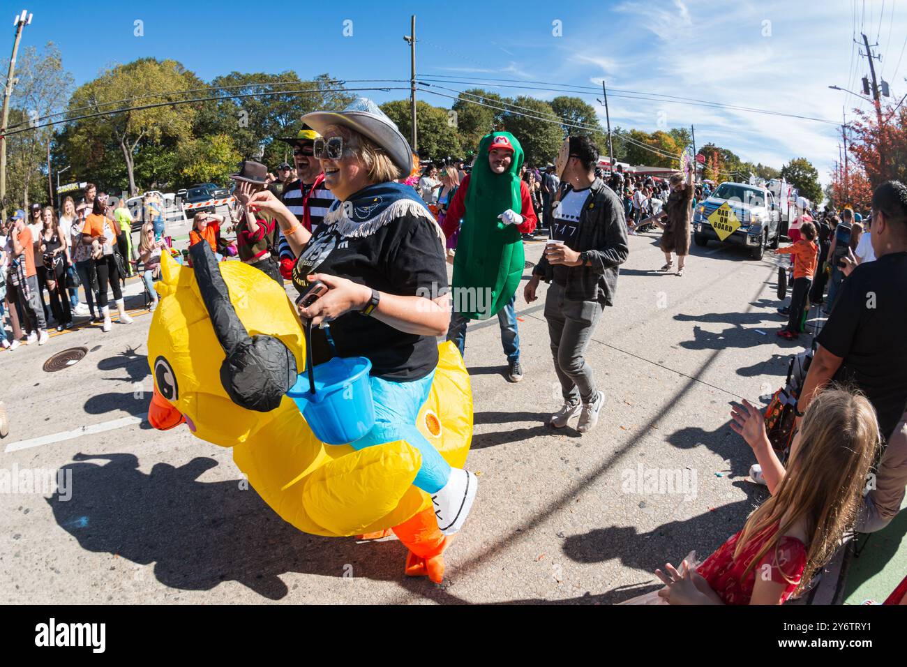 Atlanta, GA / USA - October 22, 2023: Woman rides a giant rubber ducky ...