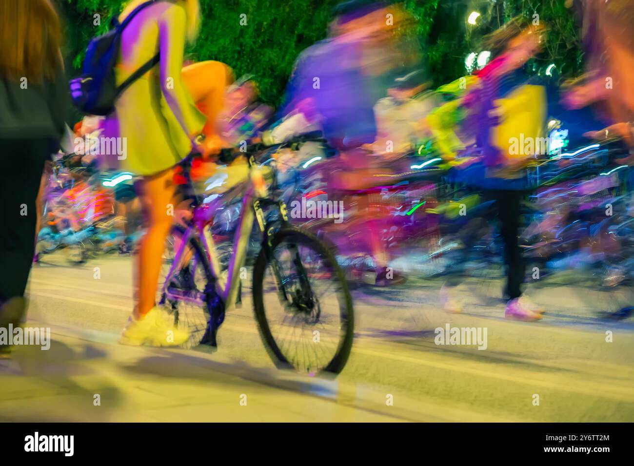 Blurred background of Lively night bike ride through a crowded urban ...