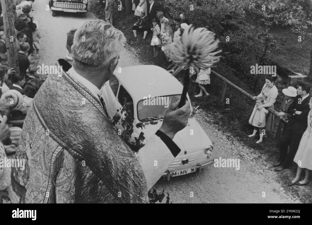 RELIGION - A PRIEST BLESSING A MOTOR CAR AND DRIVERS ON ST CHRISTOPHER ...