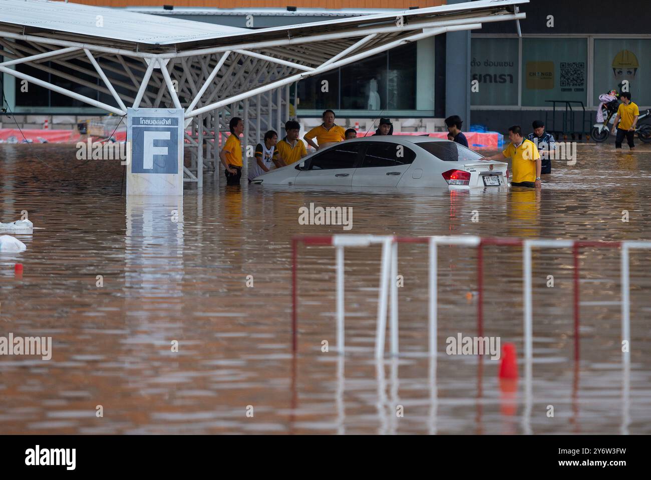 A car seen submerged in deep floodwaters in Tha Wang Tan Subdistrict ...