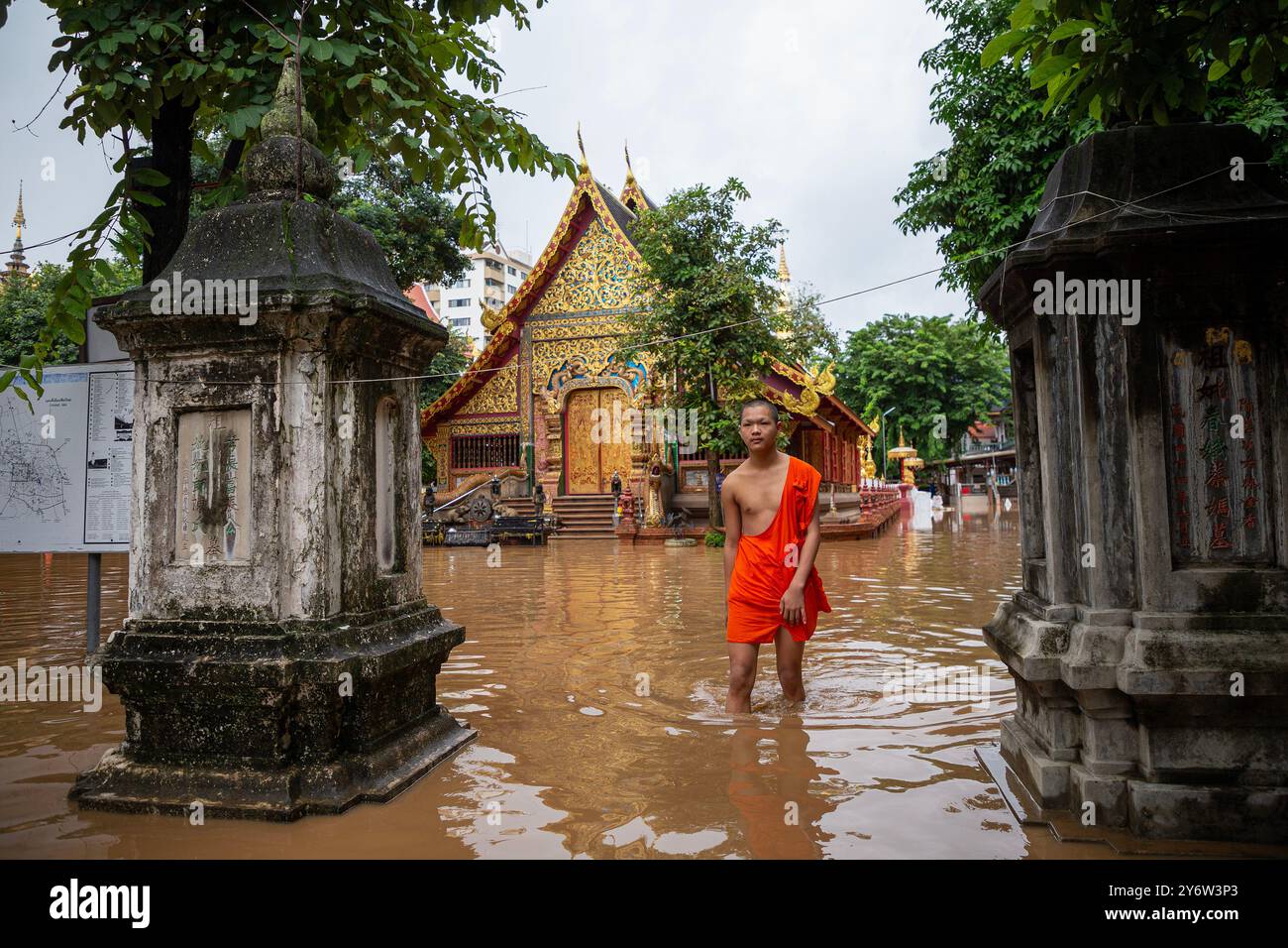 A novice monk seen walking inside a flooded temple. Continuous rainfall ...