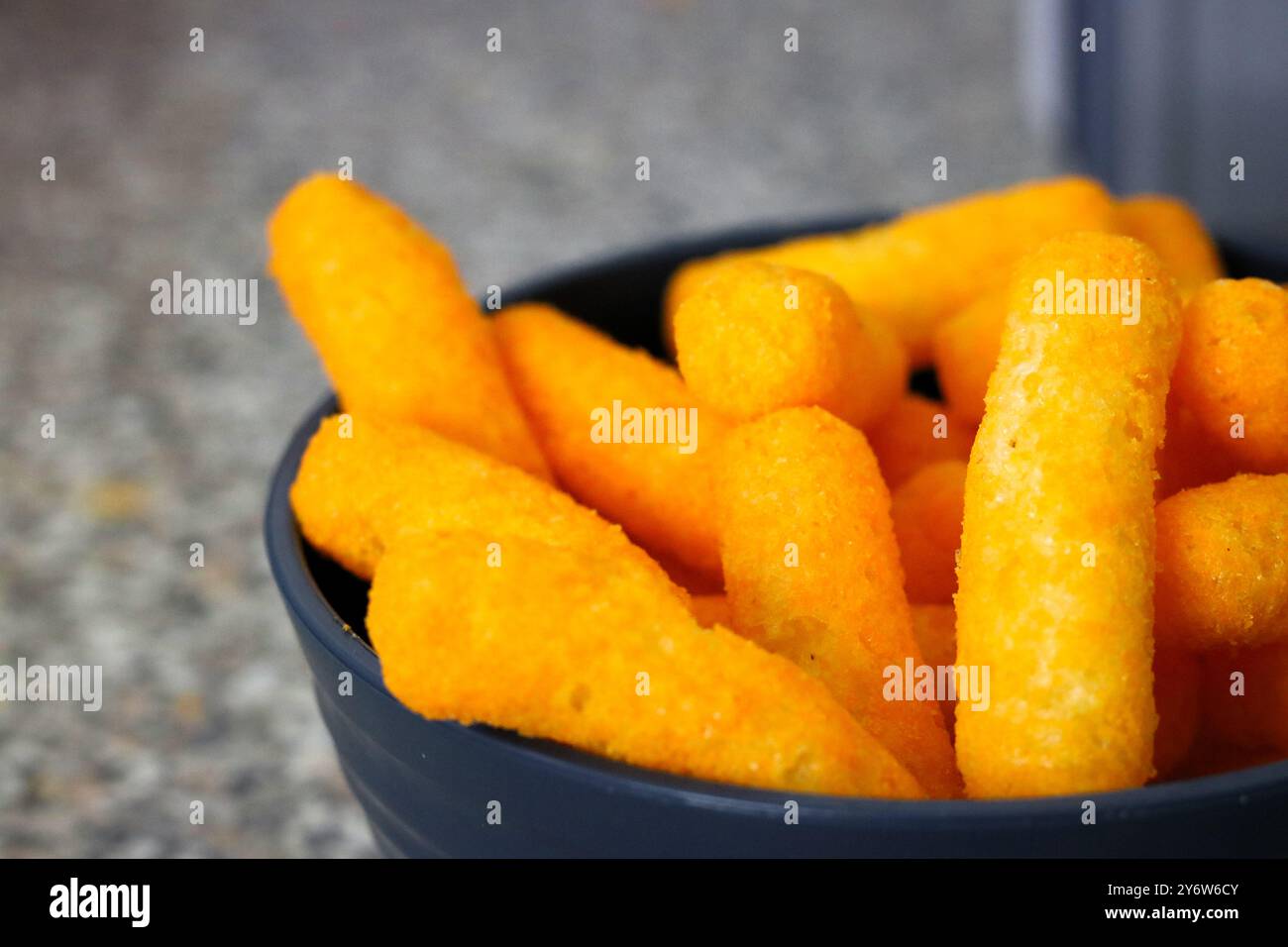 Cheese puffs close up in a bowl on the kitchen Stock Photo - Alamy
