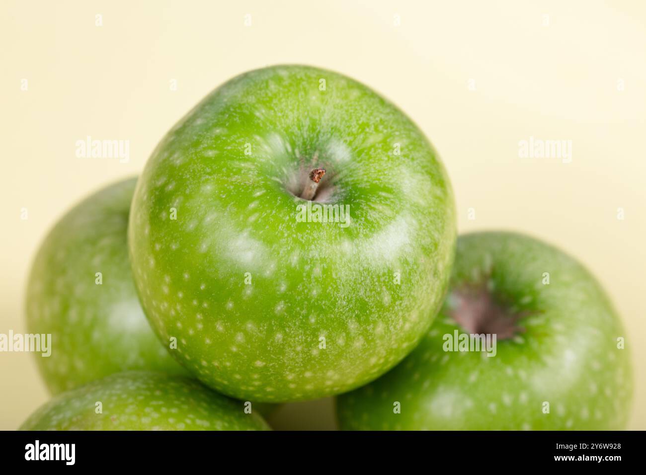 Fresh Green Apples: Trio of Crisp Granny Smith Fruits on Pale Yellow ...