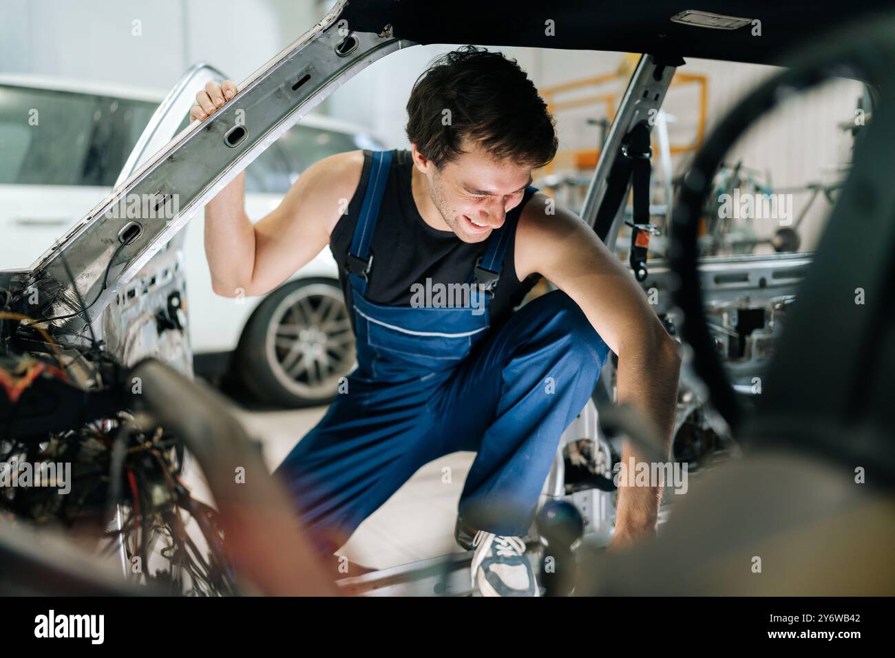 Portrait from interior of old vehicle to smiling mechanic male ...