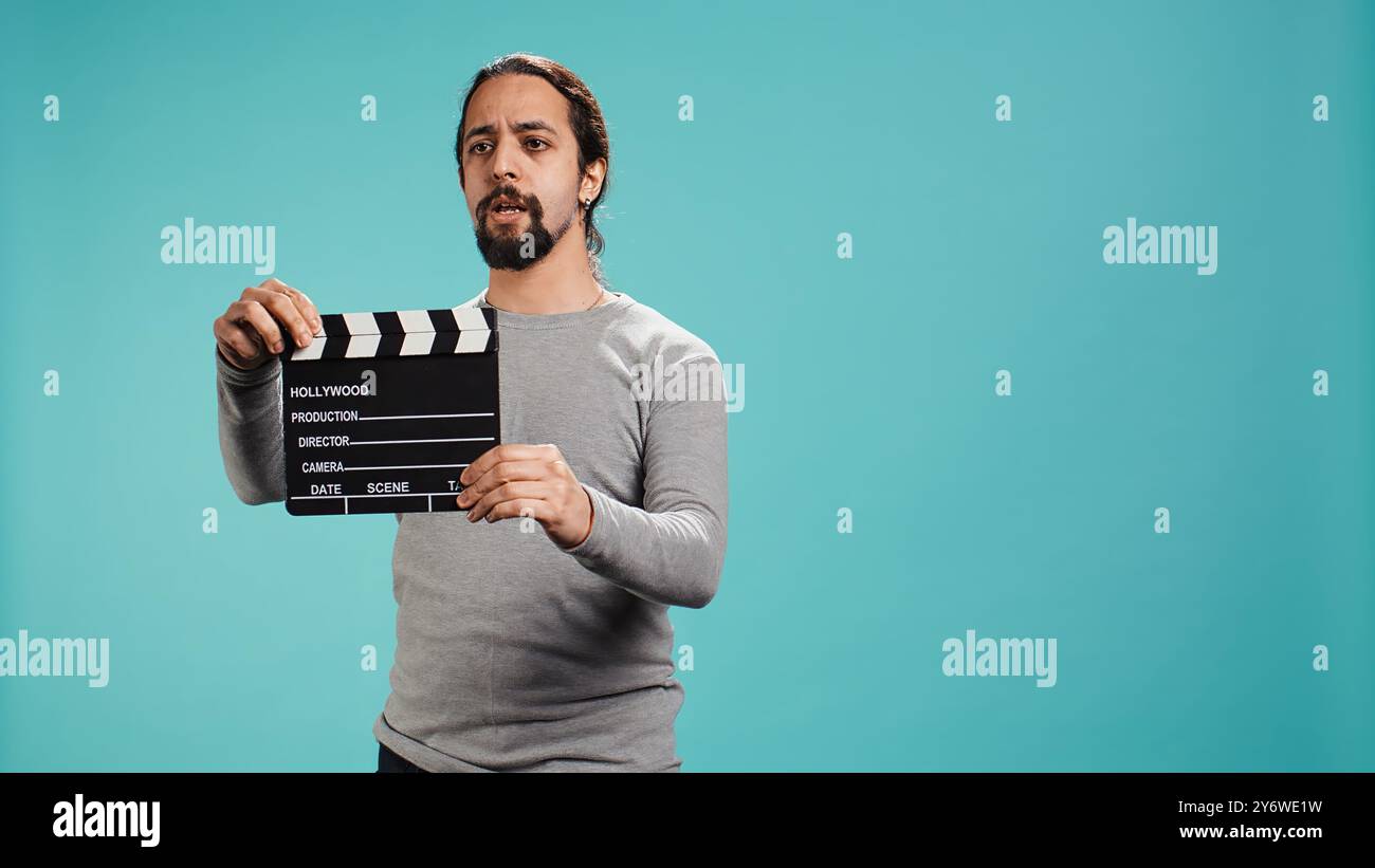 Movie director using clapper to signal actors beginning of scene ...