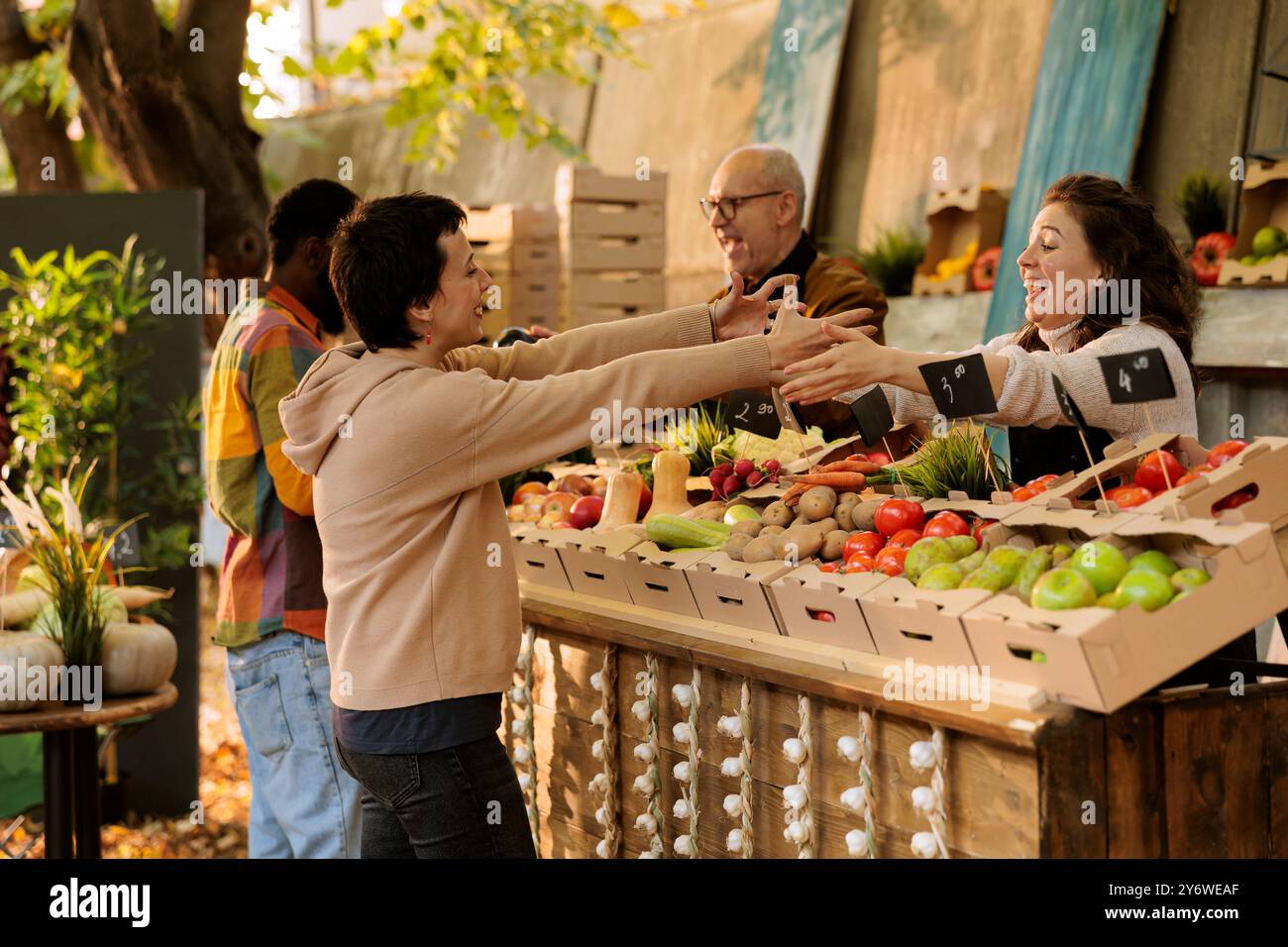 Excited local vendor greeting favorite customer at greenmarket stand ...
