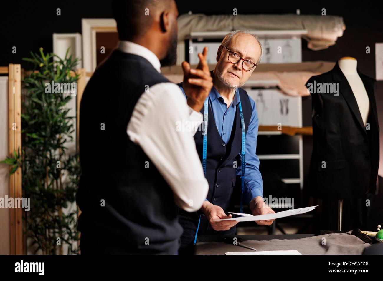 Teamworking fashion designers brainstorming upcoming sartorial luxury ...