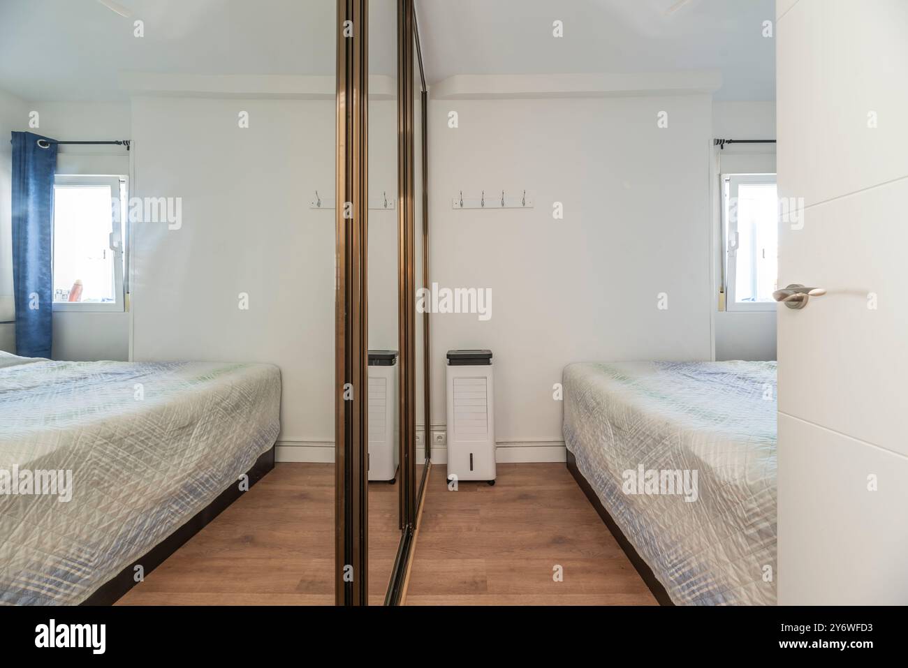 Small bedroom with a queen-size bed taking up space and a wall-to-wall ...