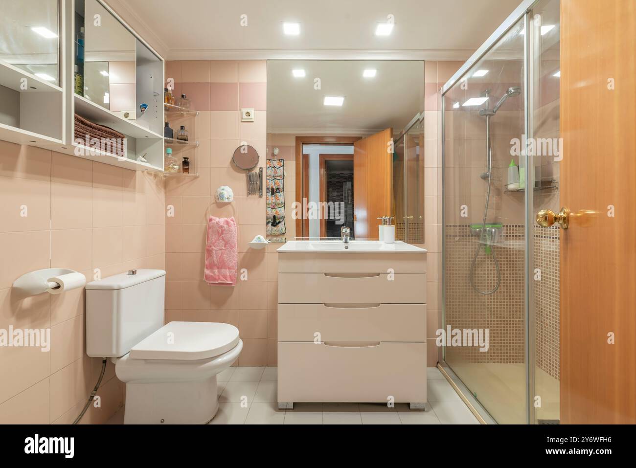 A conventional bathroom with a flat-floor shower cabin, frameless ...