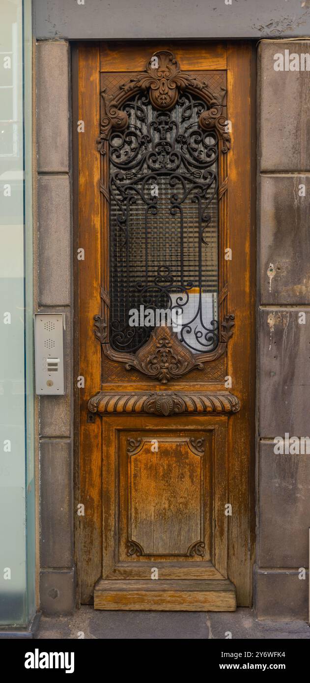 Narrow single-leaf entrance exterior wooden door, with glass and metal ...