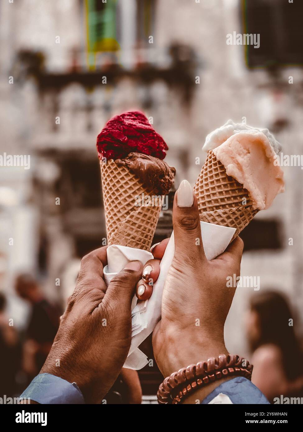 Portrait of hands holding ice cream cone make a toast Stock Photo - Alamy