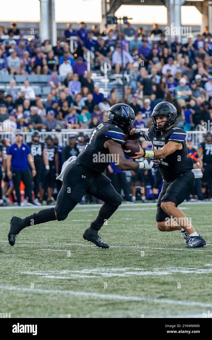 Jack Lausch (12) QB for Northwestern hands off the ball to Cam Porter ...