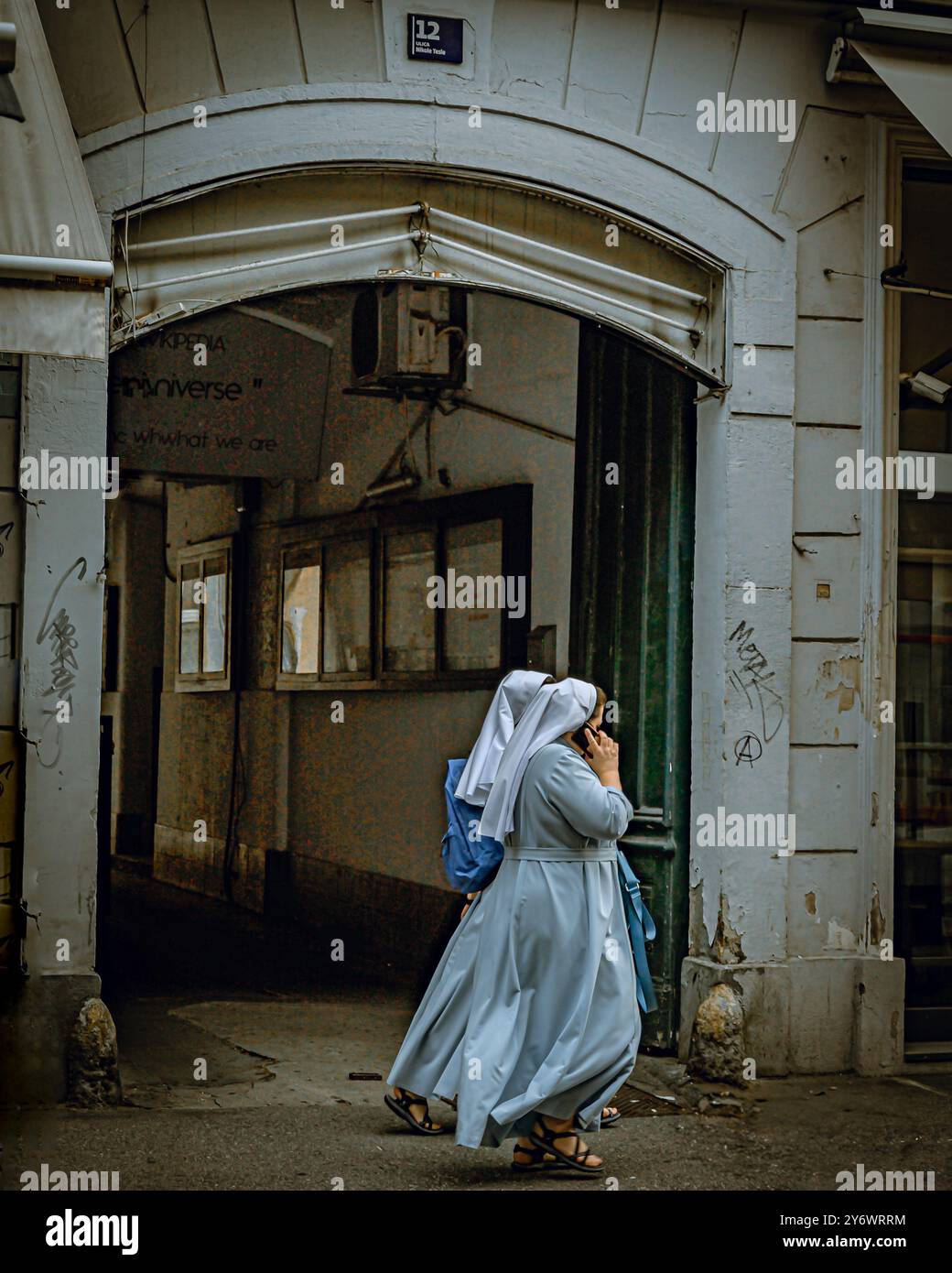 Two Catholic nuns walking in street front of old Church in Croatia ...
