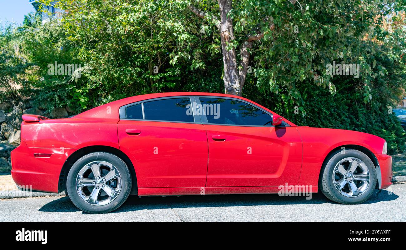 Seattle, WA, USA -July 3, 2024: 2013 Dodge Charger orange side view ...