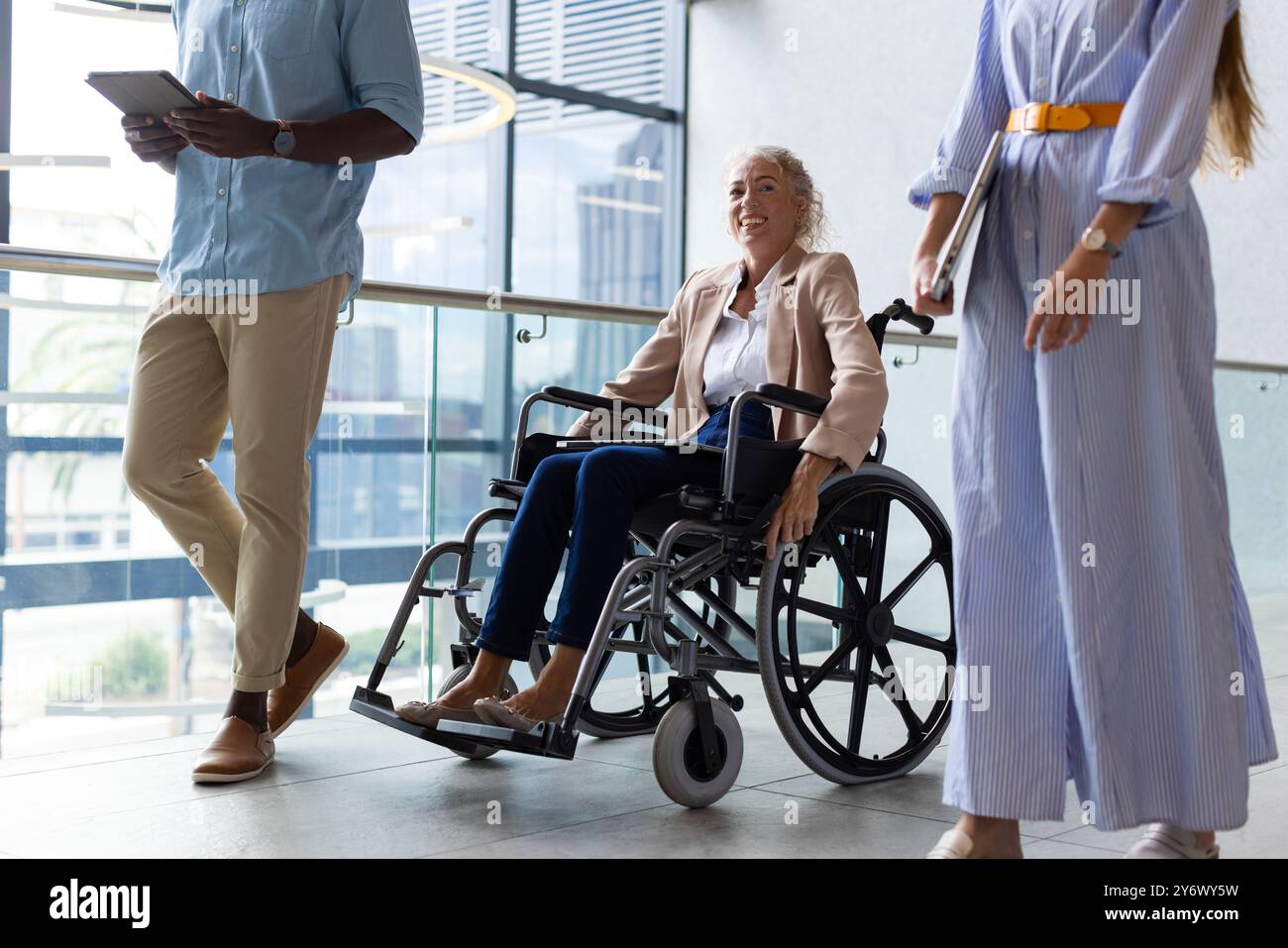 Discussing work, business professionals walking with woman in ...