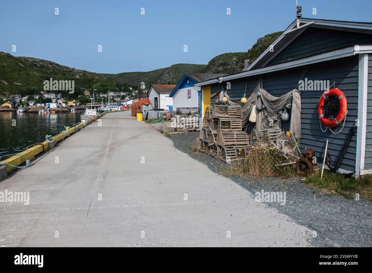 Fishing nets and lobster traps stored on the dock in Petty Harbour ...