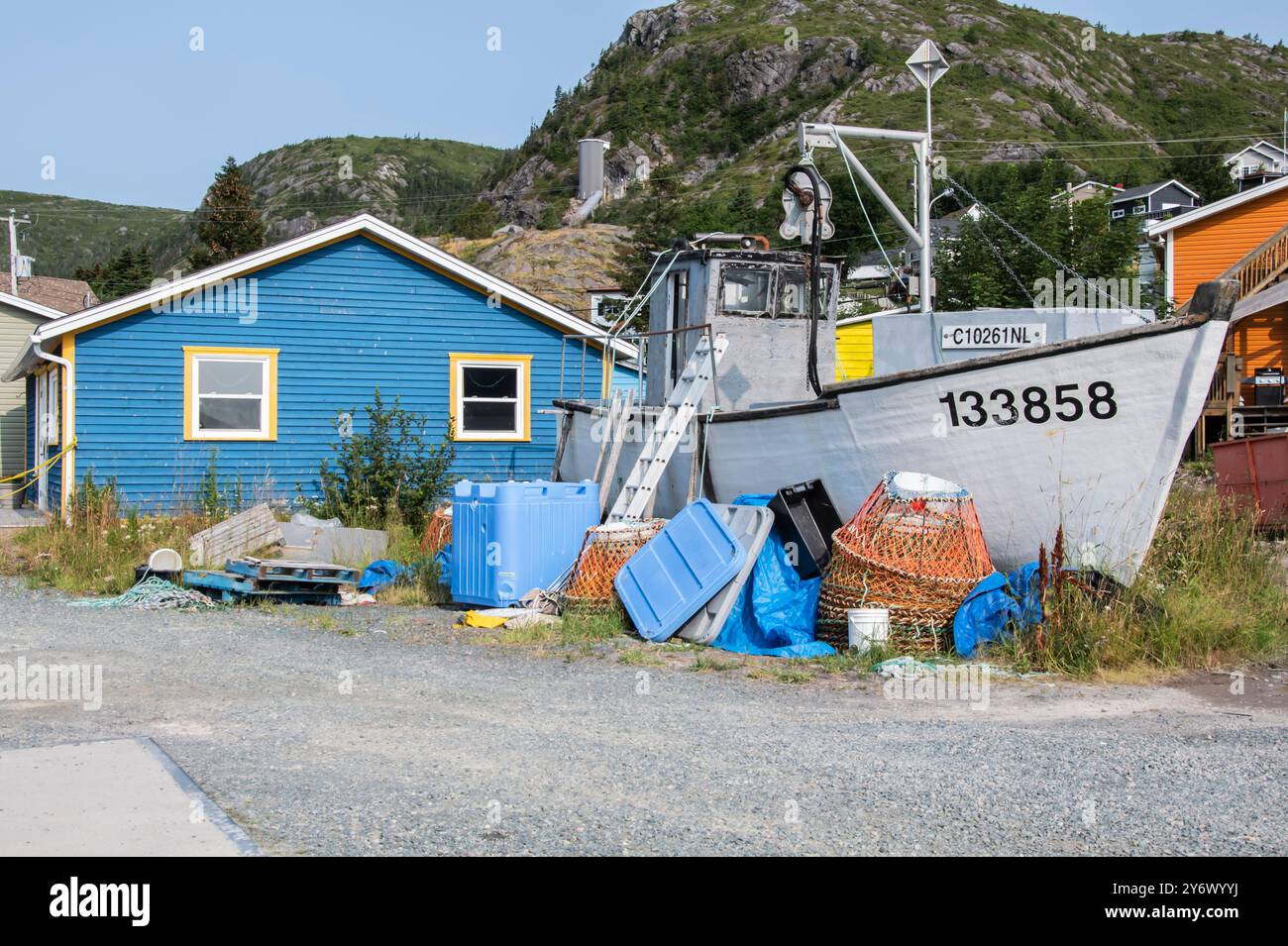 White fishing boat stored in the grass in Petty Harbour–Maddox Cove ...