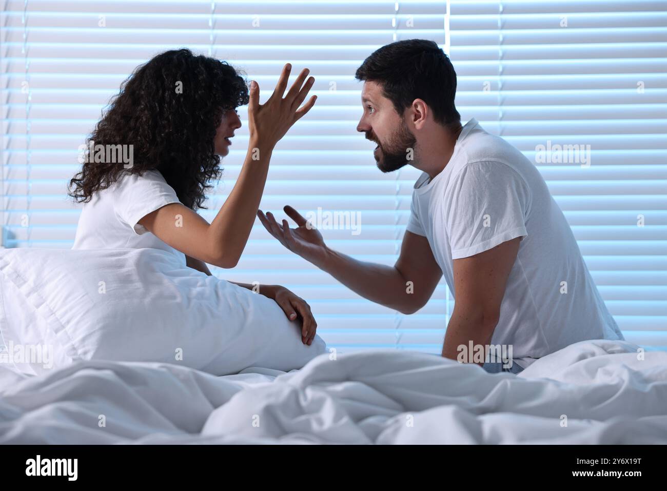Emotional couple arguing in bedroom at night. Relationship problems ...