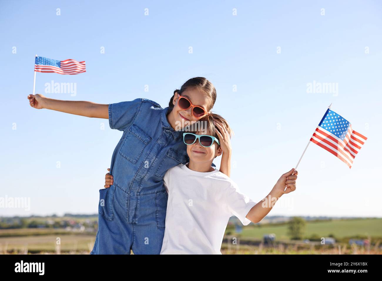 Brother and sister with flags of USA outdoors Stock Photo - Alamy