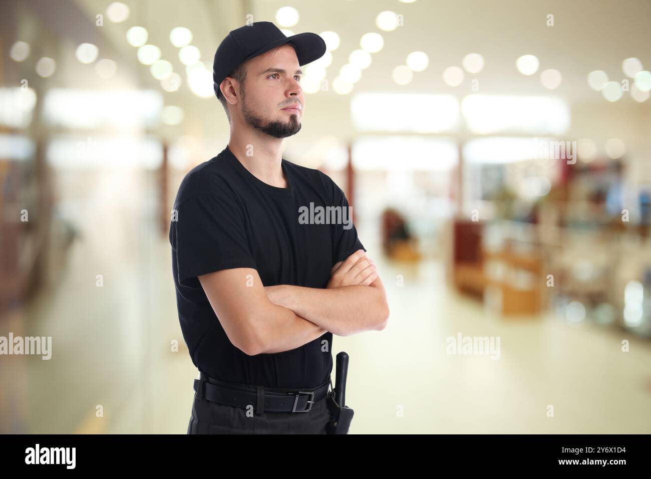 Portrait of serious security guard in shopping mall. Space for text ...