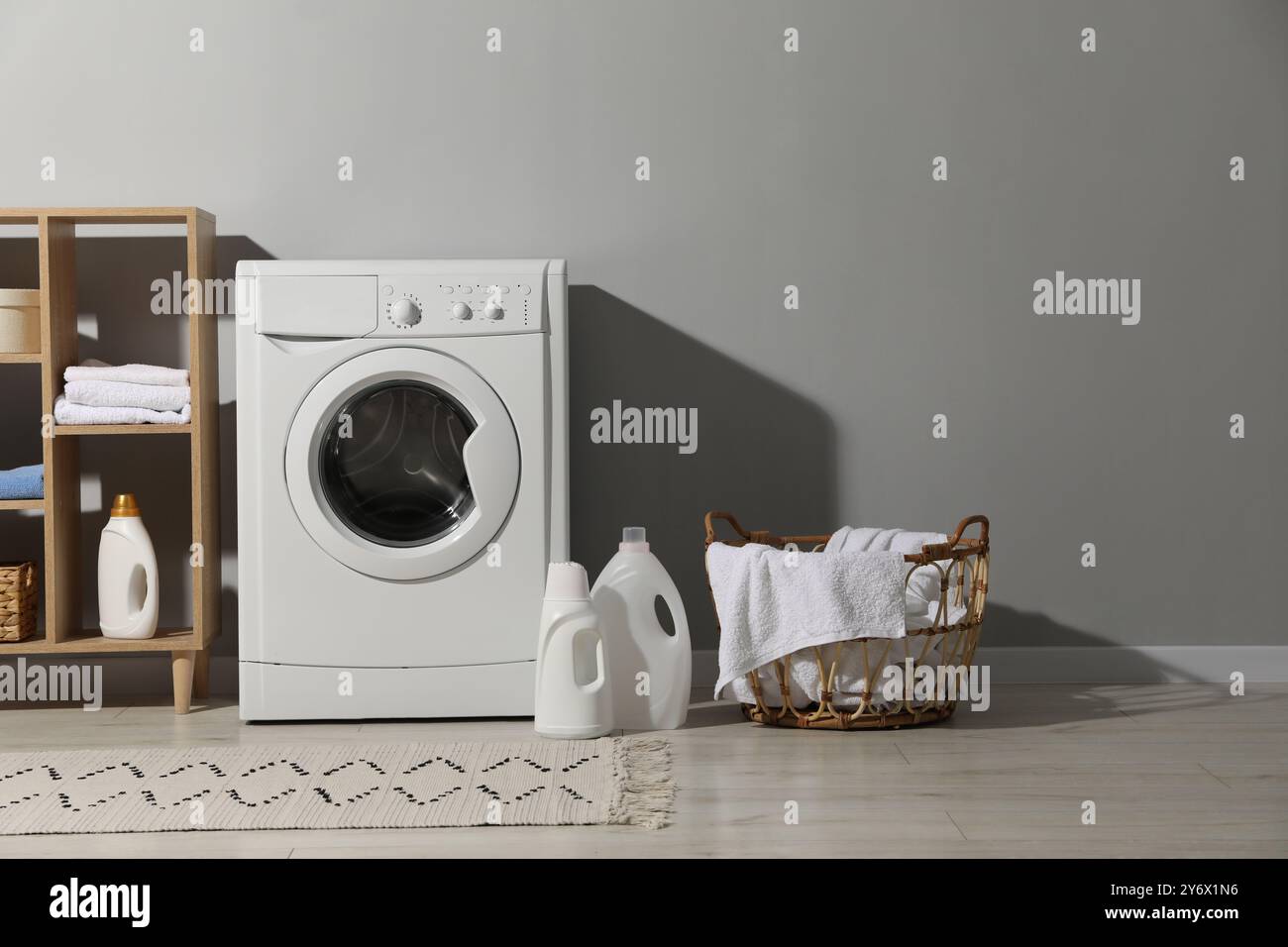 Washing machine, towels and detergents in laundry room Stock Photo - Alamy
