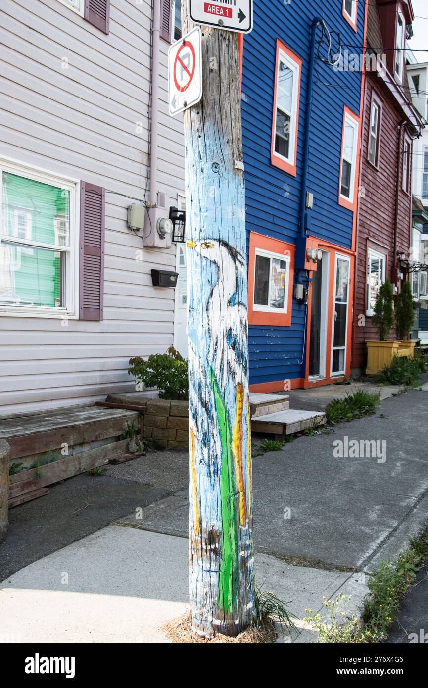 White bird mural on a wooden utility pole in downtown St. John's ...