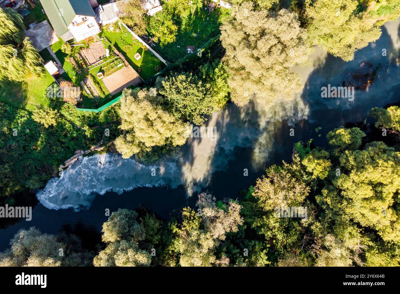 Aerial view of sewage treatment plant sewer discharge into river ...