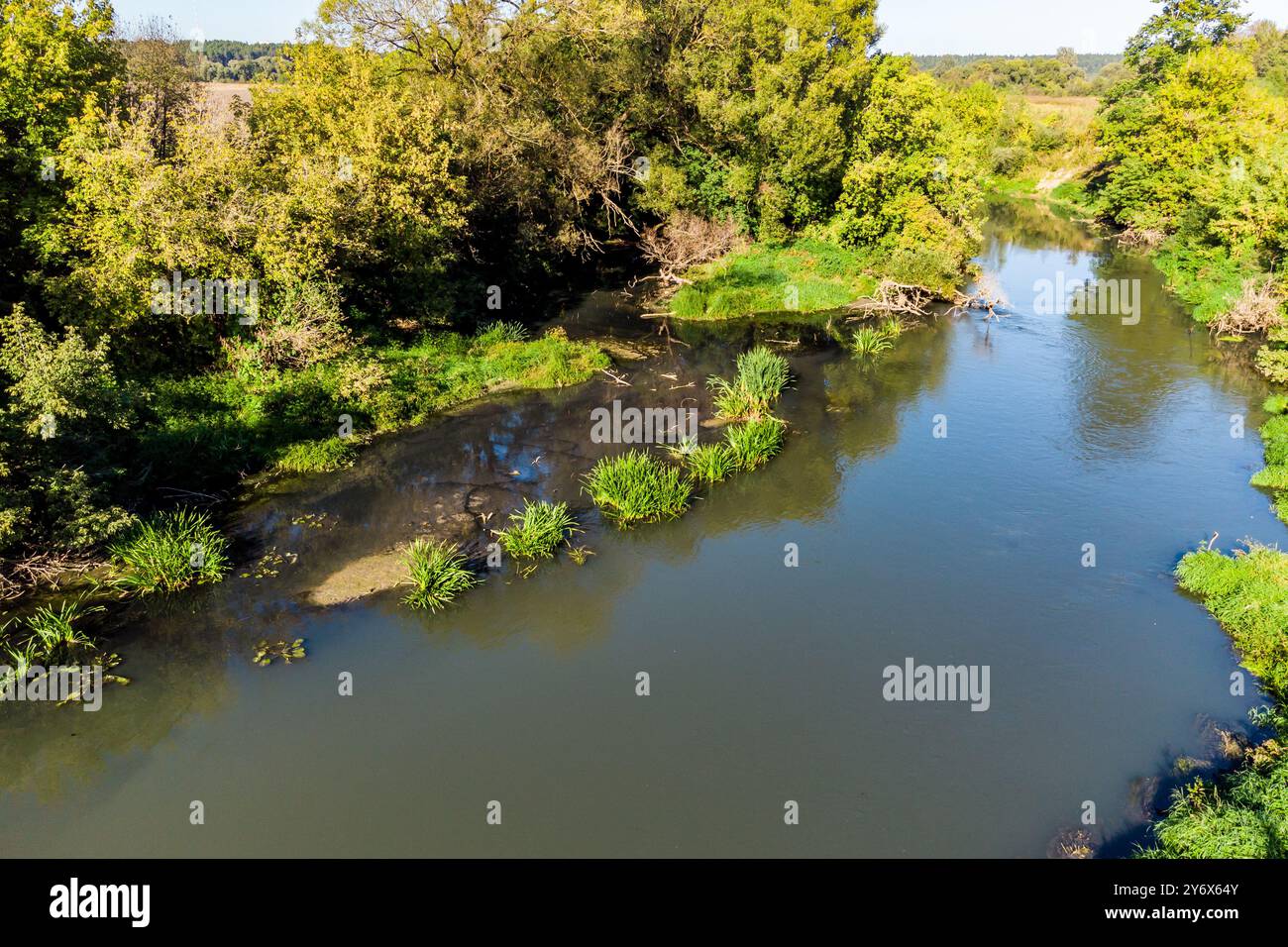 Low altitude view of a river bed with muddy water Stock Photo - Alamy