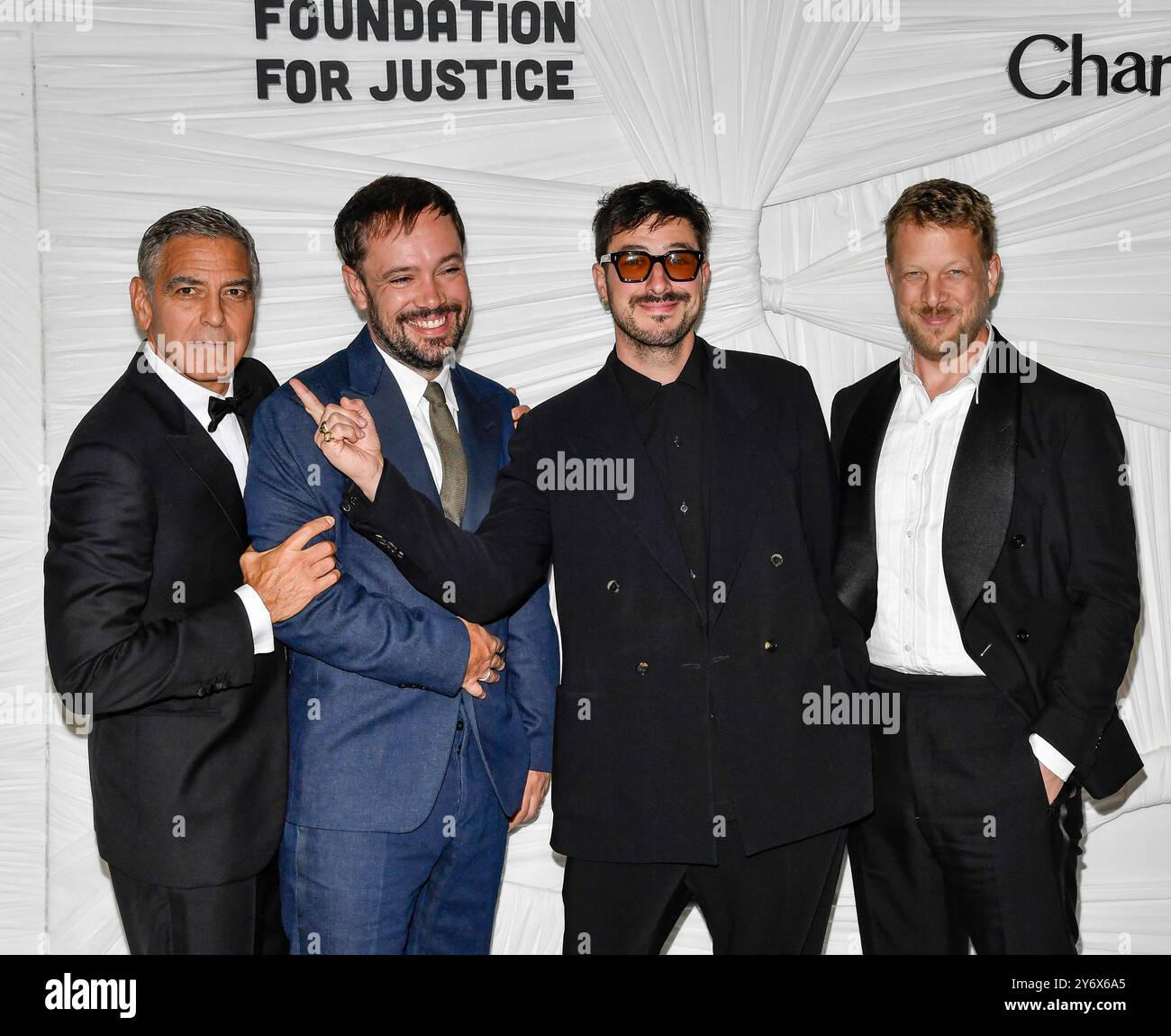 George Clooney, left, joins Ben Lovett, Marcus Mumford and Ted Dwane of ...