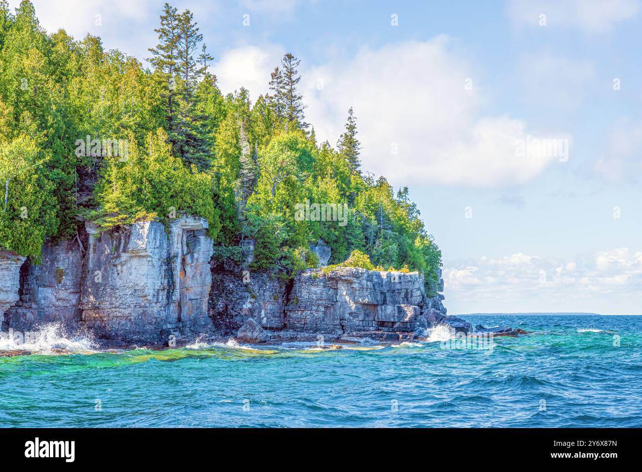 Waves lash the rocky shoreline and cliffs of flowerpot island in ...