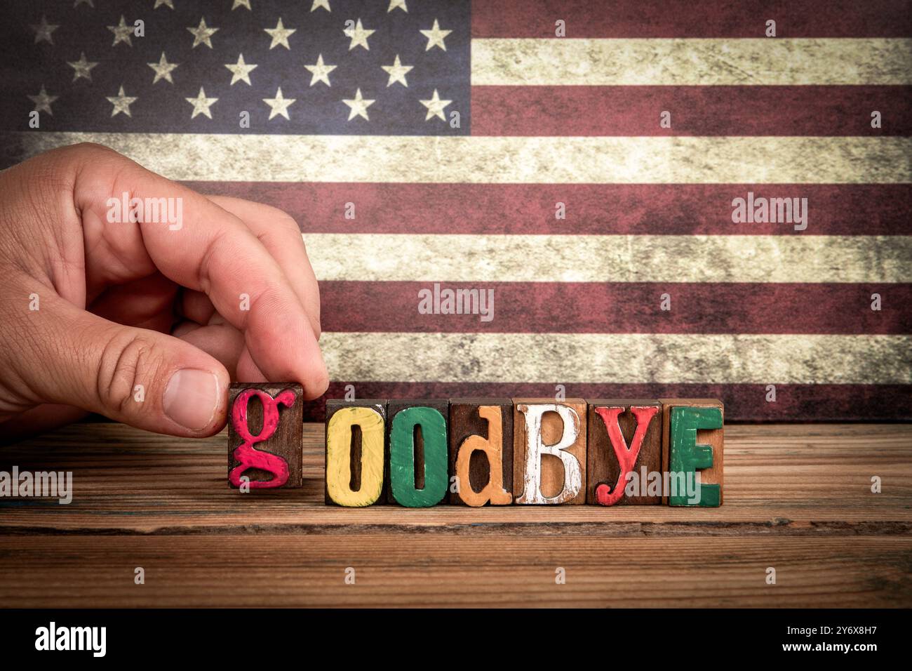 GOODBYE. Colorful letters of the alphabet on a wooden texture table ...