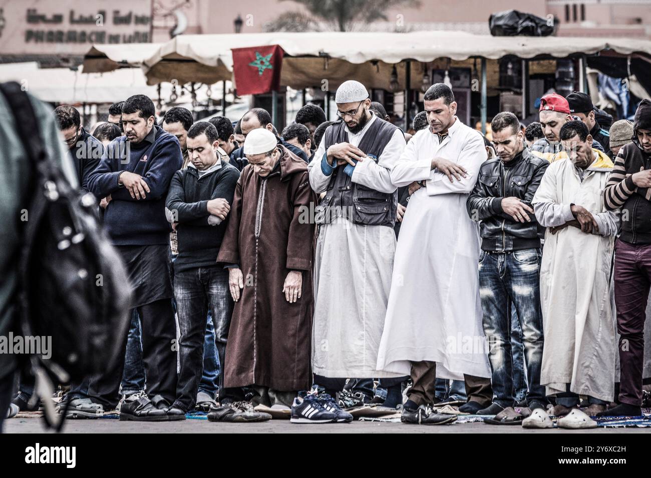 Muslims praying in front of a mosque, Jamaa el Fna Square, Marrakech ...
