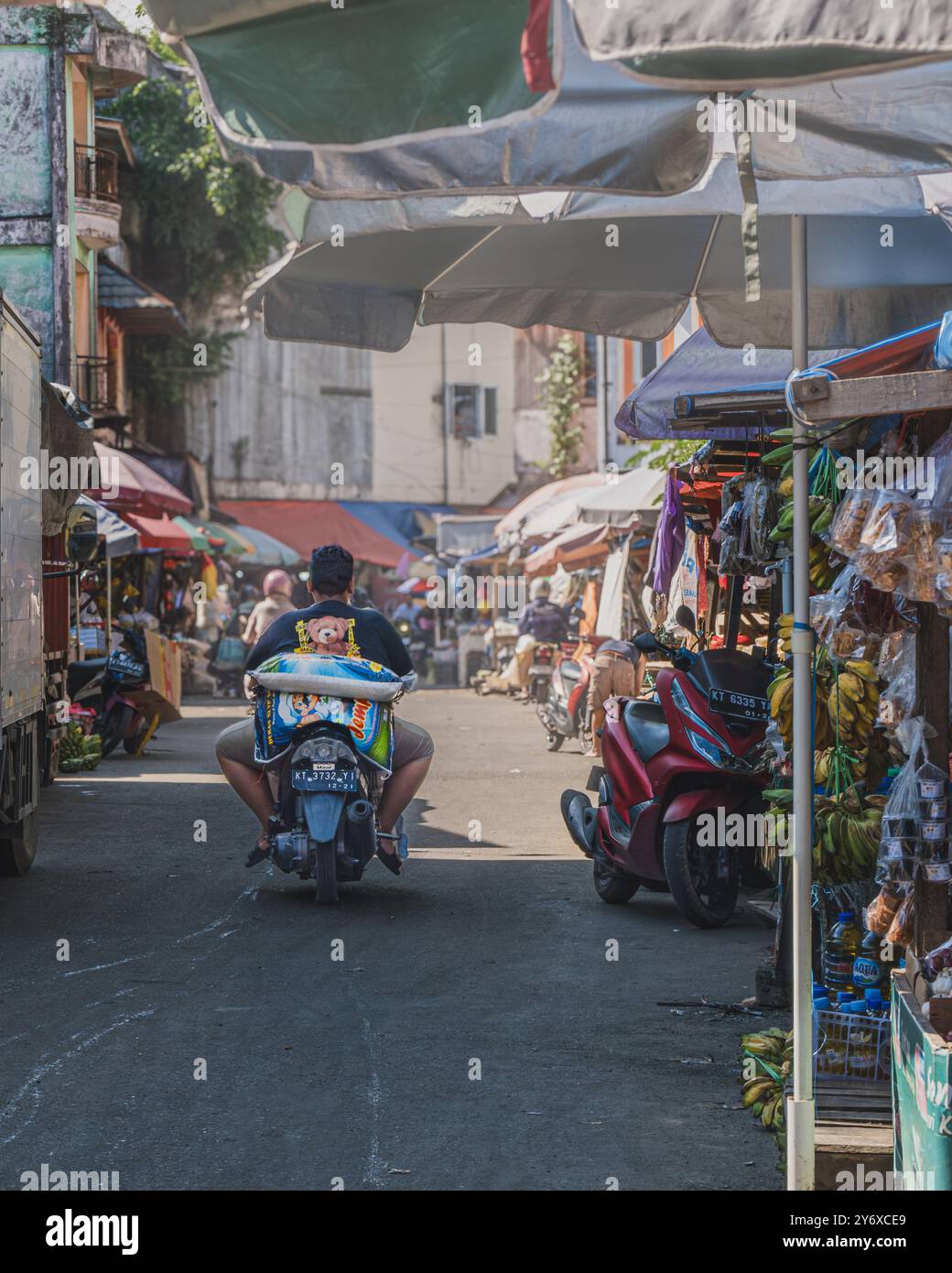 Balikpapan, Indonesia - June 26th, 2024. He is carrying a sack of rice ...