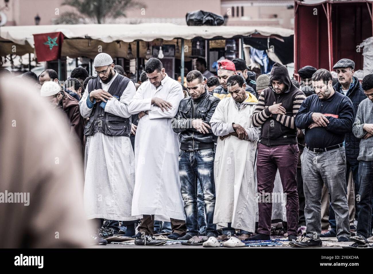 Muslims praying in front of a mosque, Jamaa el Fna Square, Marrakech ...