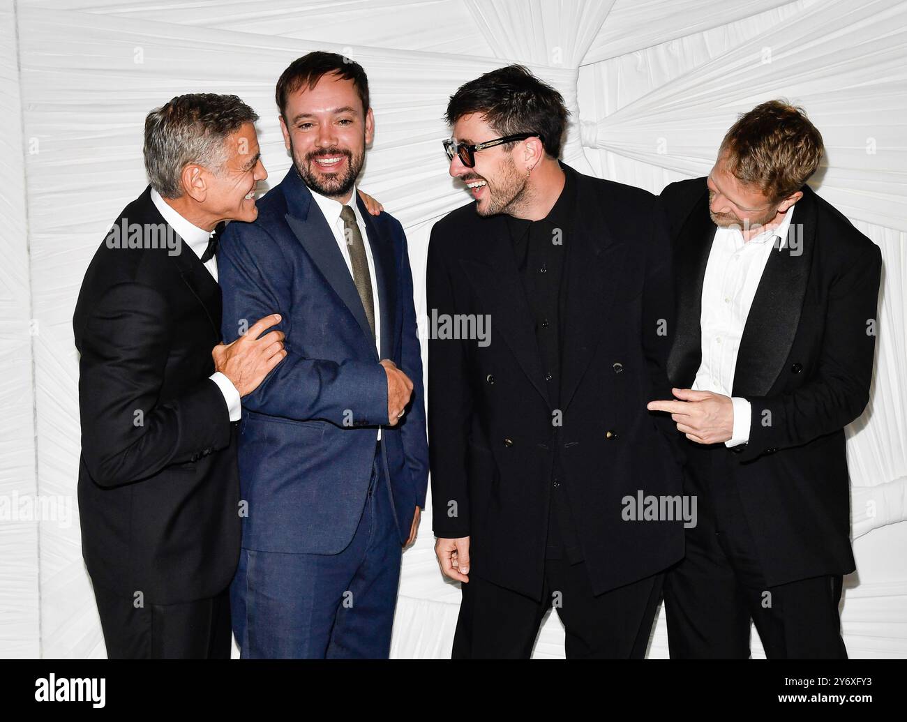 George Clooney, left, joins Ben Lovett, Marcus Mumford and Ted Dwane of ...