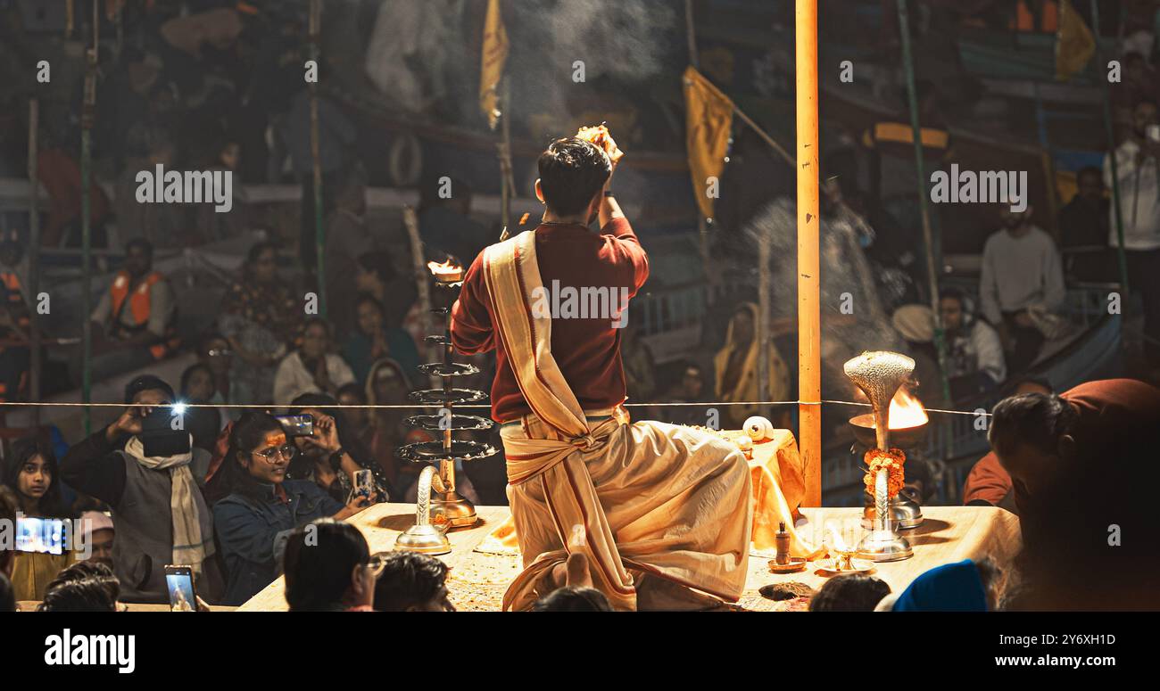 Varanasi, India. Brahmin Priest Making Movements With Flowers Marigolds ...