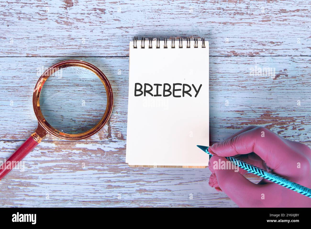 BRIBERY word written there is a handwritten inscription in the notebook ...