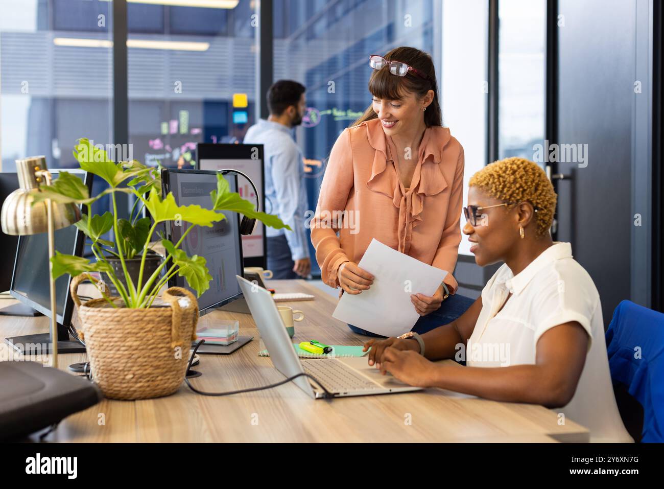 Collaborating office desk businesswomen using hi-res stock photography ...